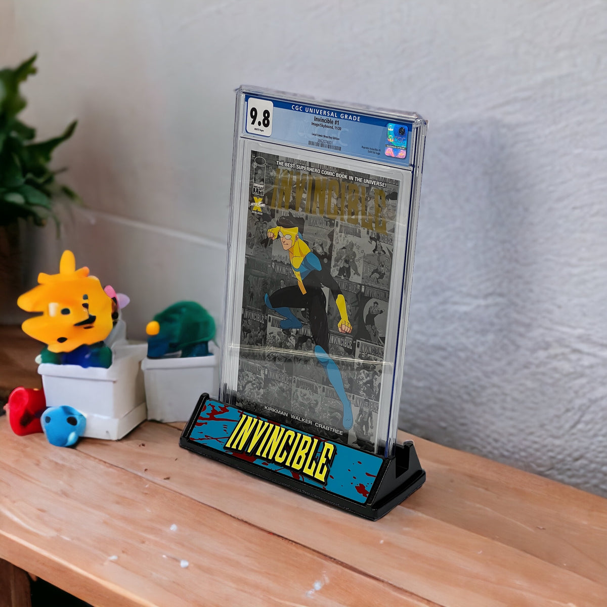 Invincible Comic Stand (Blood Splatter) – Red Wolf Collectibles